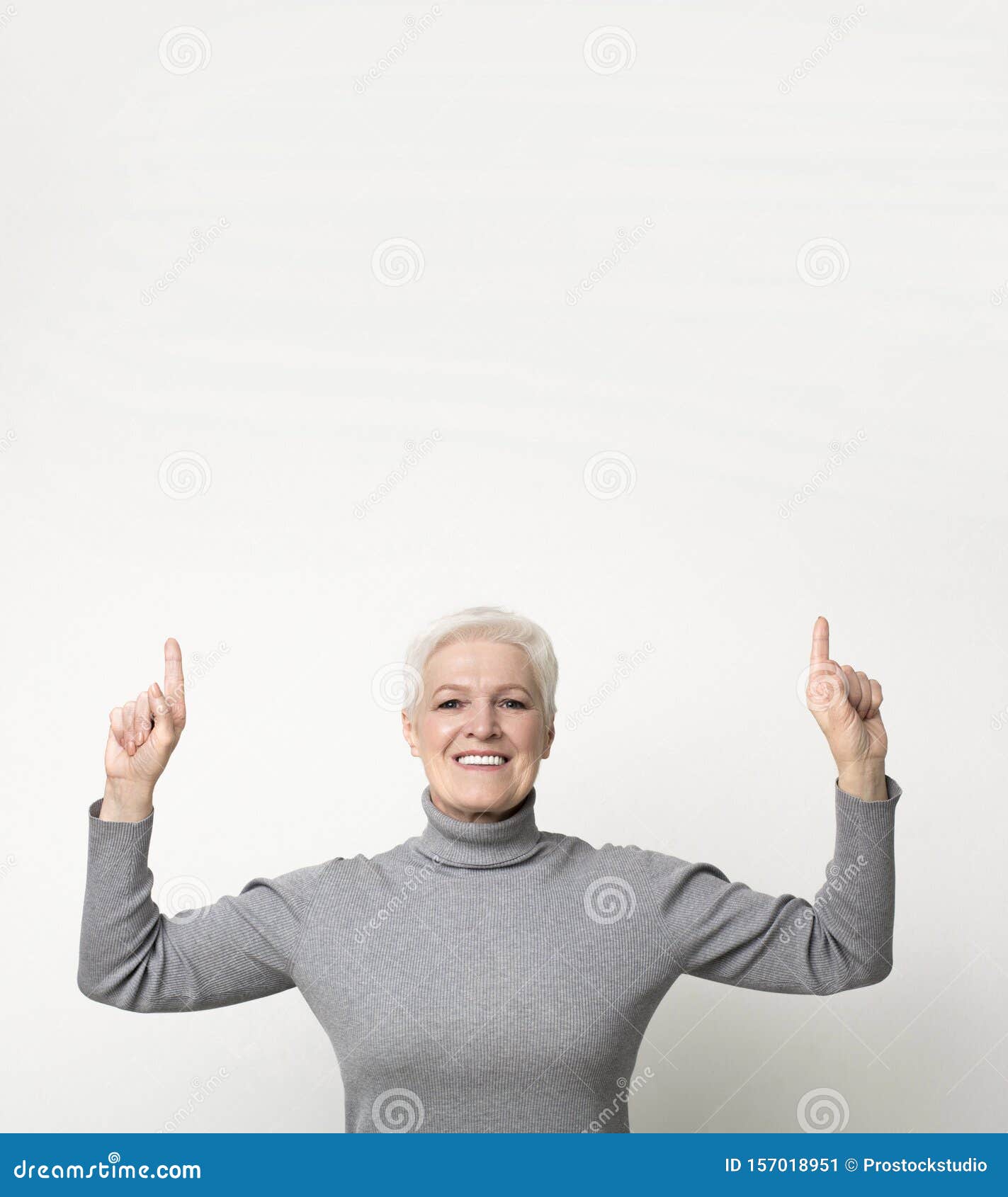 Beautiful Elderly Woman Pointing Upwards on Copy Space Stock Image ...