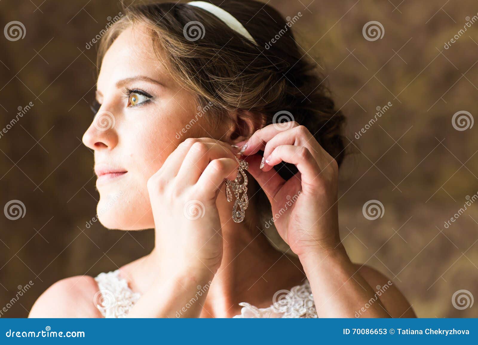 Beautiful Elegant Bride Putting On Earrings Closeup Wedding