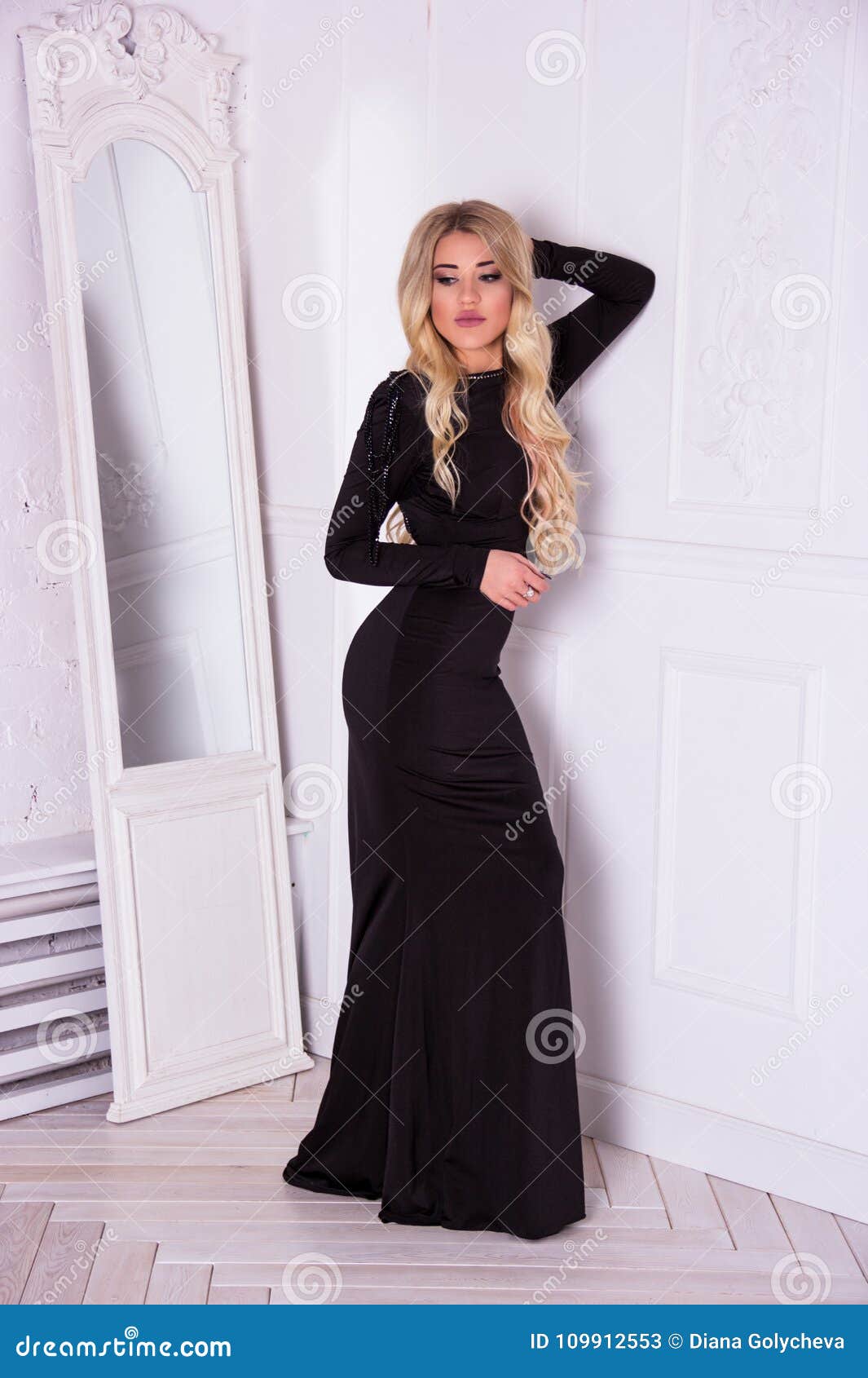 Beautiful Elegant Woman Posing in Black Dress Near Mirror. Stock Image ... Beautiful Elegant Woman Posing in Black Dress Near Mirror. Stock Image ...