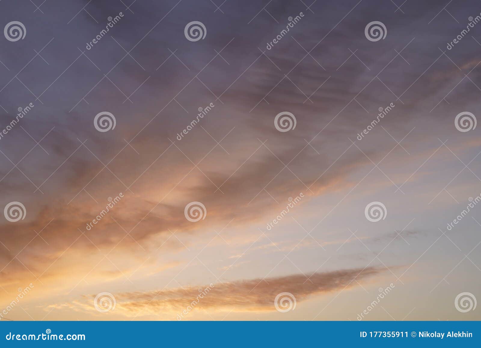 A Beautiful Evening Blue Sky at Sunset with Flaming Bright Light Clouds ...