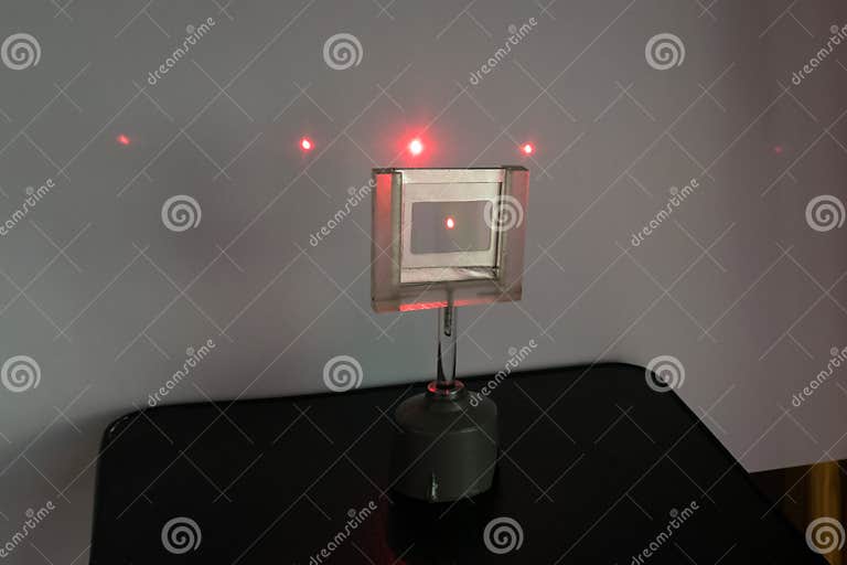 Red Laser Light Passes through a Grating, Causing Diffraction Stock ...