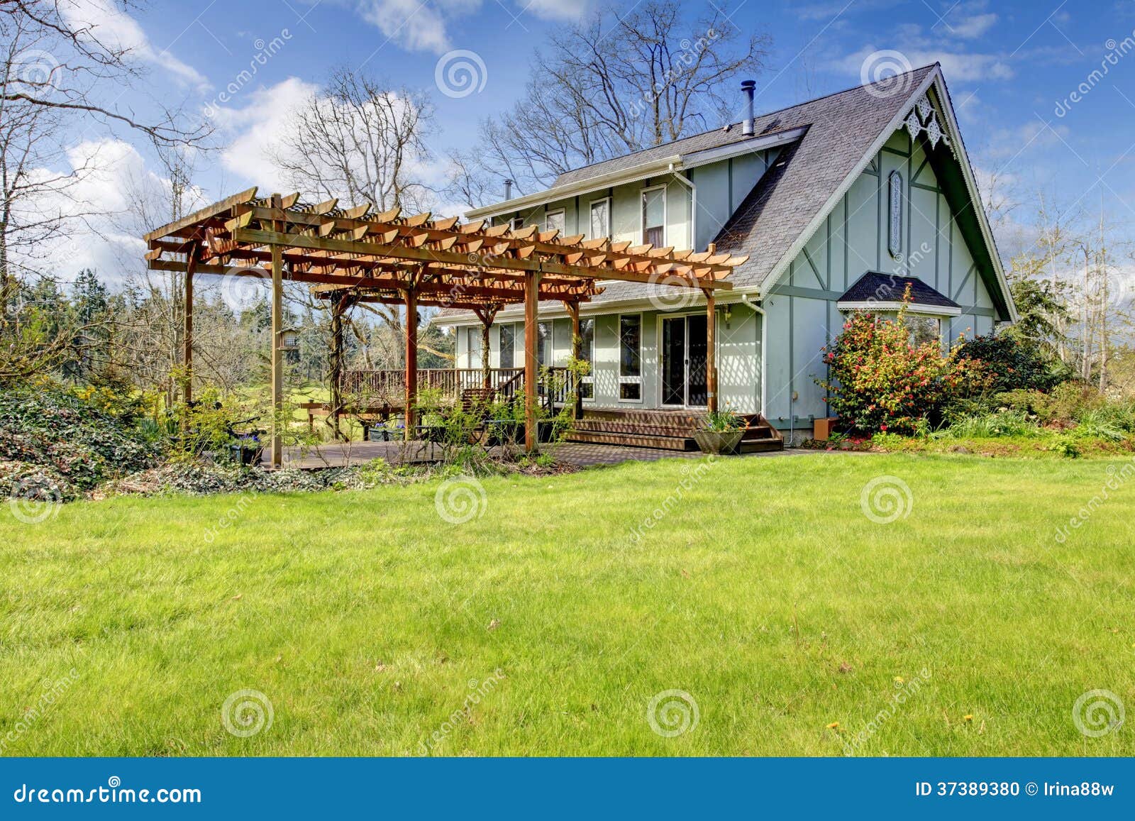 Beautiful Farmhouse with Attached Pergola. Early Spring Stock Photo ...