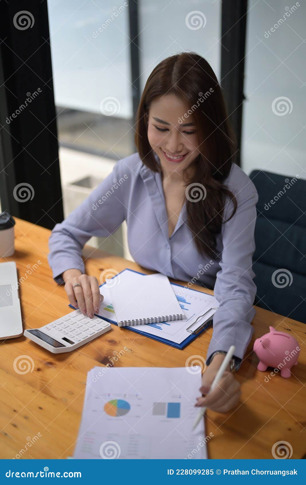 Female Accountant Analyzing Financial Documents and Using Calculator at ...