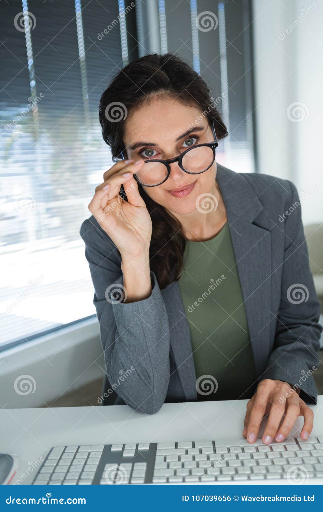 Beautiful Female Executive in Spectacles Working at Desk Stock Photo ...