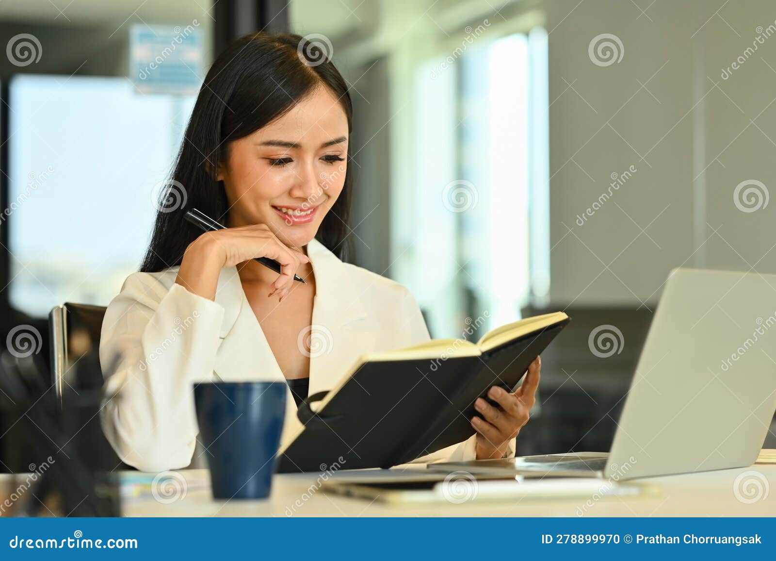 Beautiful Female Manager Making Important Notes, Planning daily ...