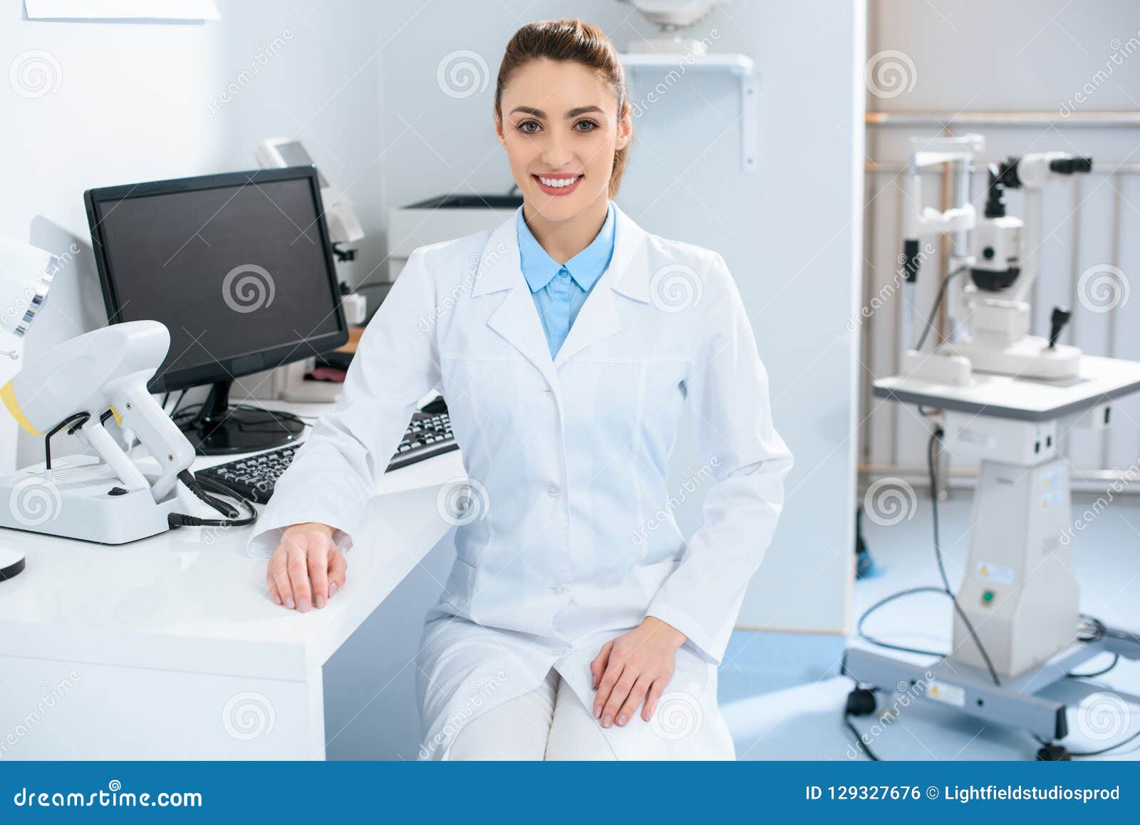 Beautiful Female Optician Working in Clinic with Computer Stock Photo ...