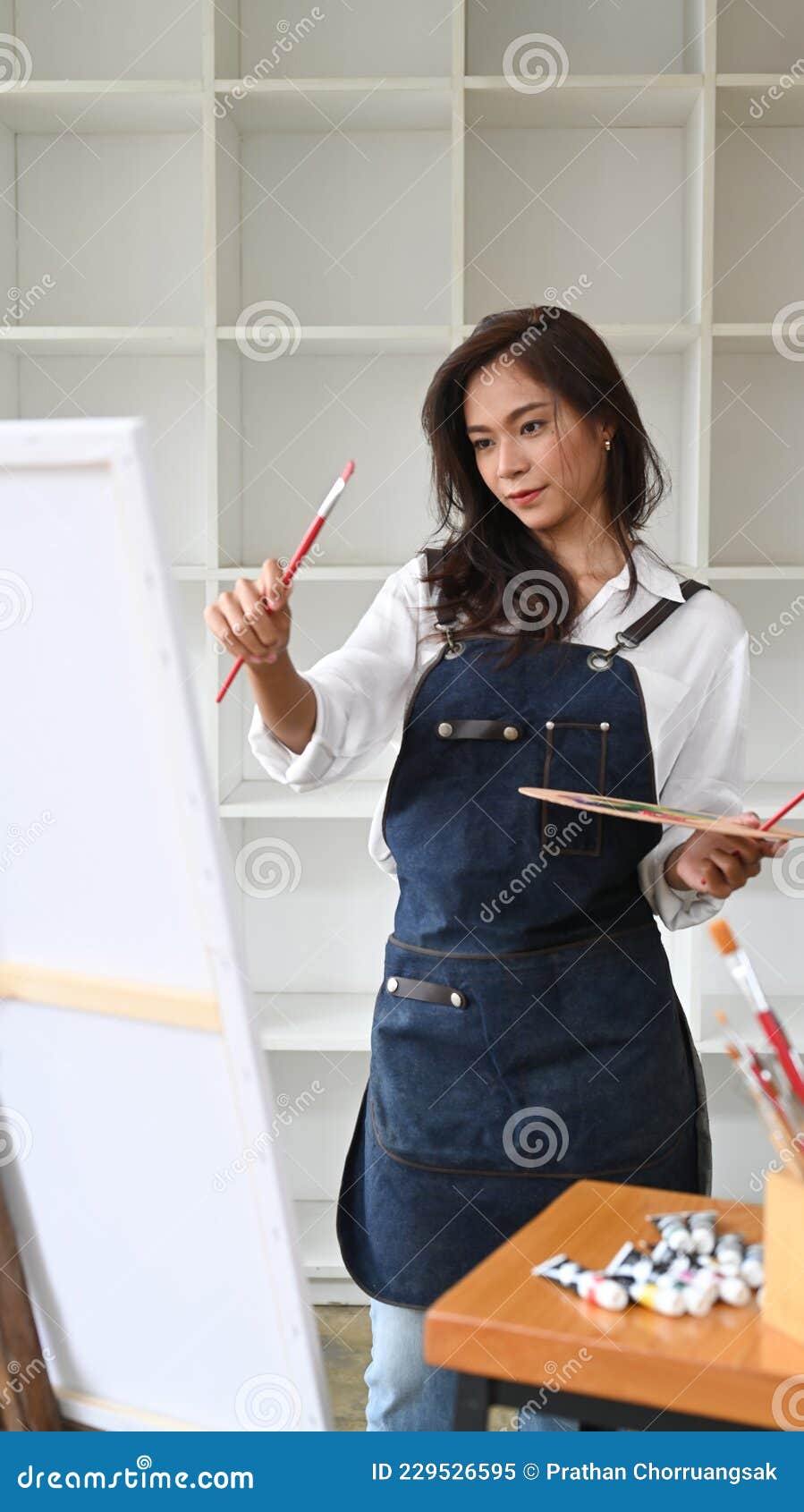 Female Painter Painting on Easel in Art Workshop. Stock Image - Image ...