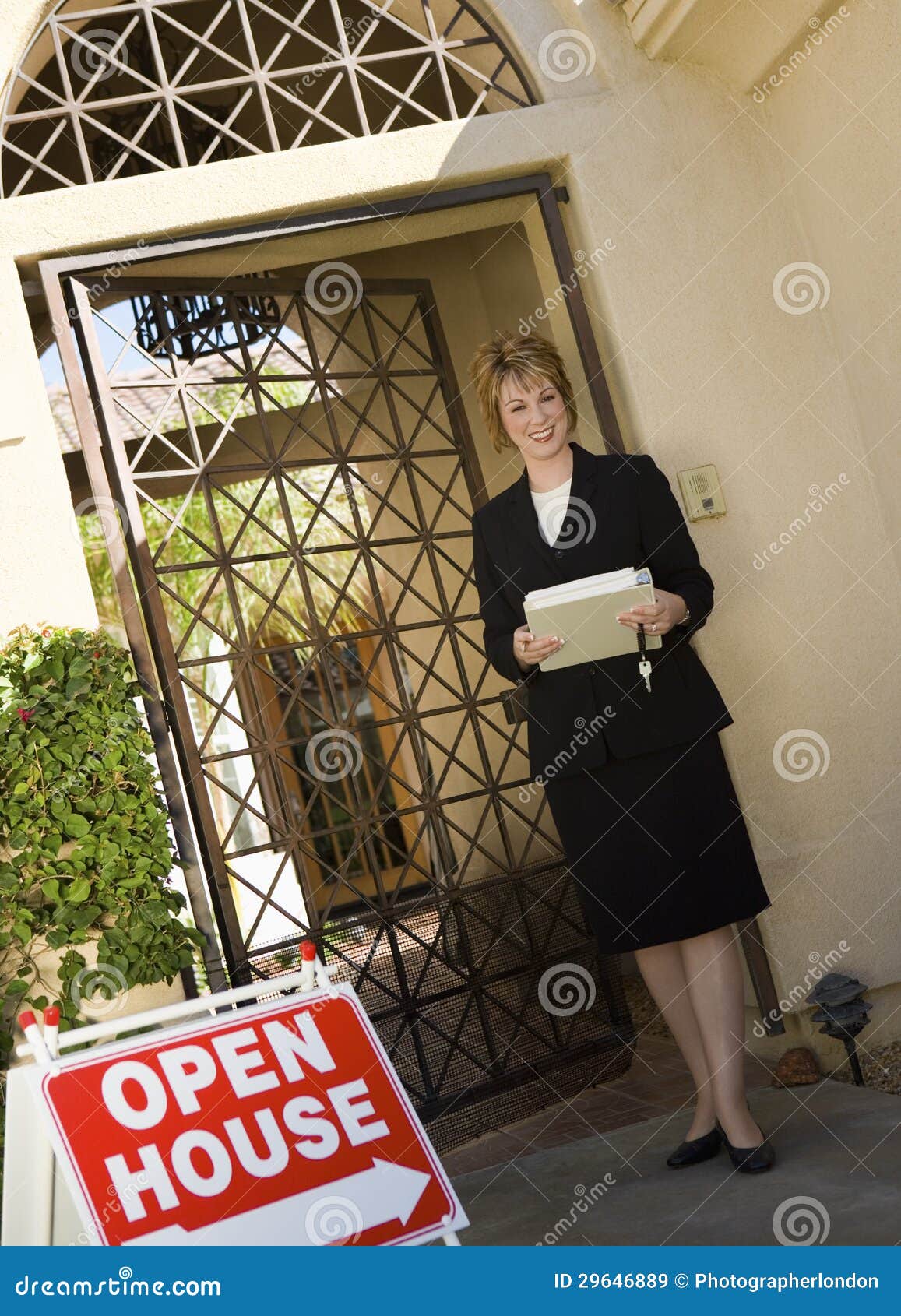 Female Real Estate Agent Holding House Key Stock Photo | CartoonDealer ...
