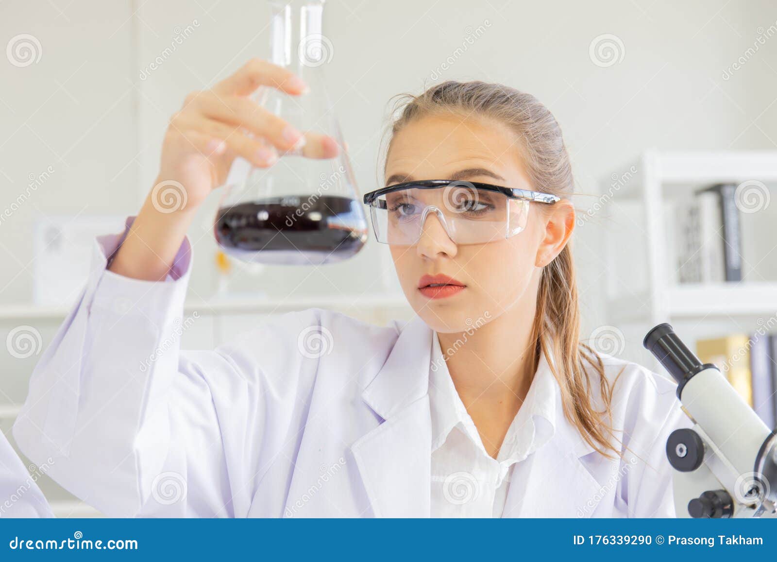 Beautiful Female Scientist is Operating in a Science Lab with Various ...