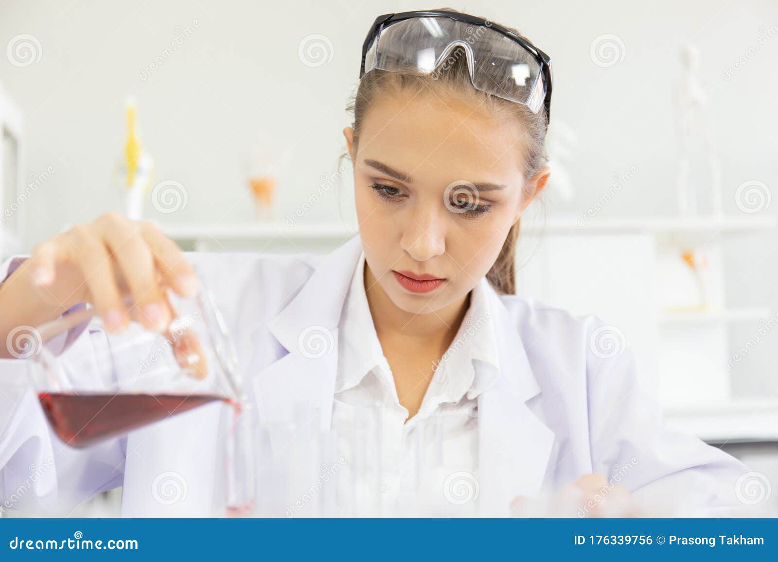 A Beautiful Female Scientist is Operating in a Science Lab with Various ...