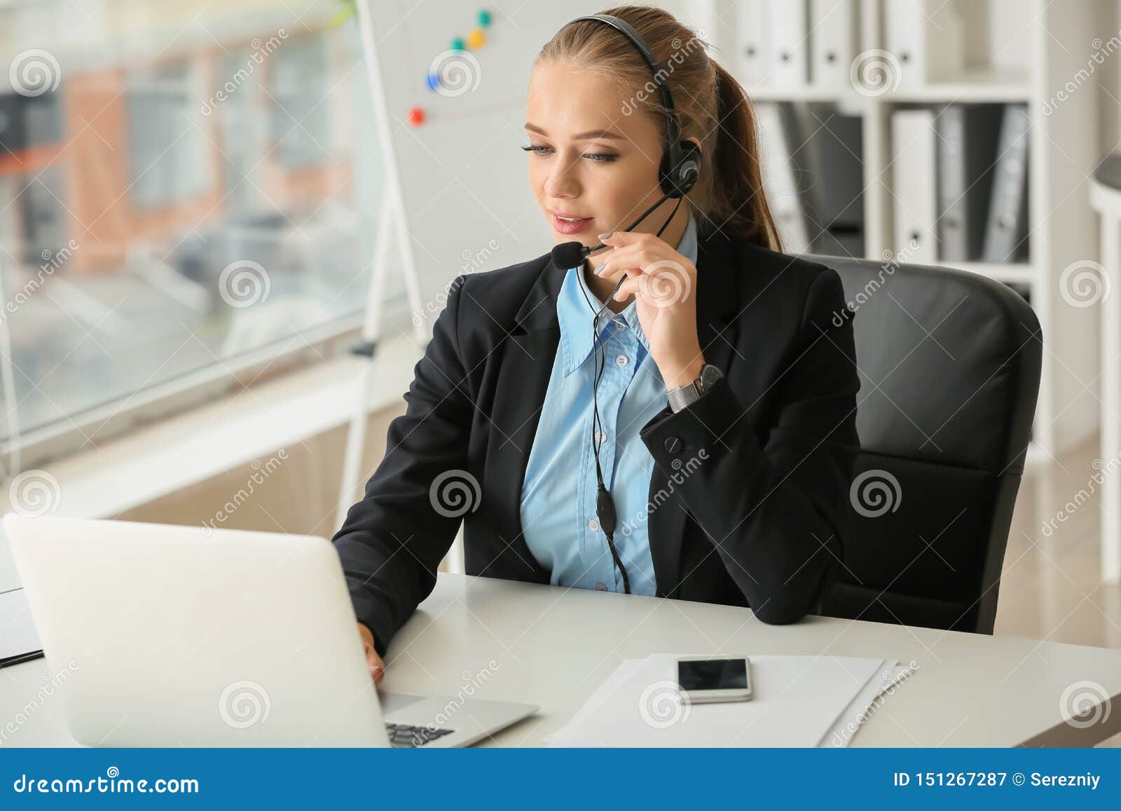 Beautiful Female Secretary Talking through Headset in Office Stock ...