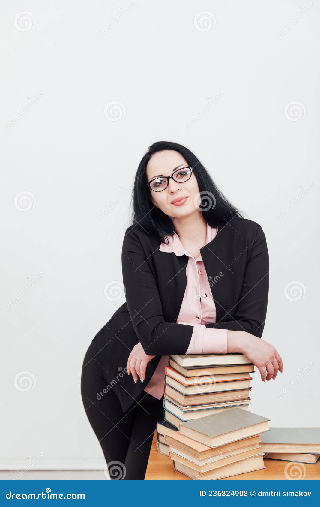 Beautiful Female Teacher at the Desk with Books for Learning Stock ...