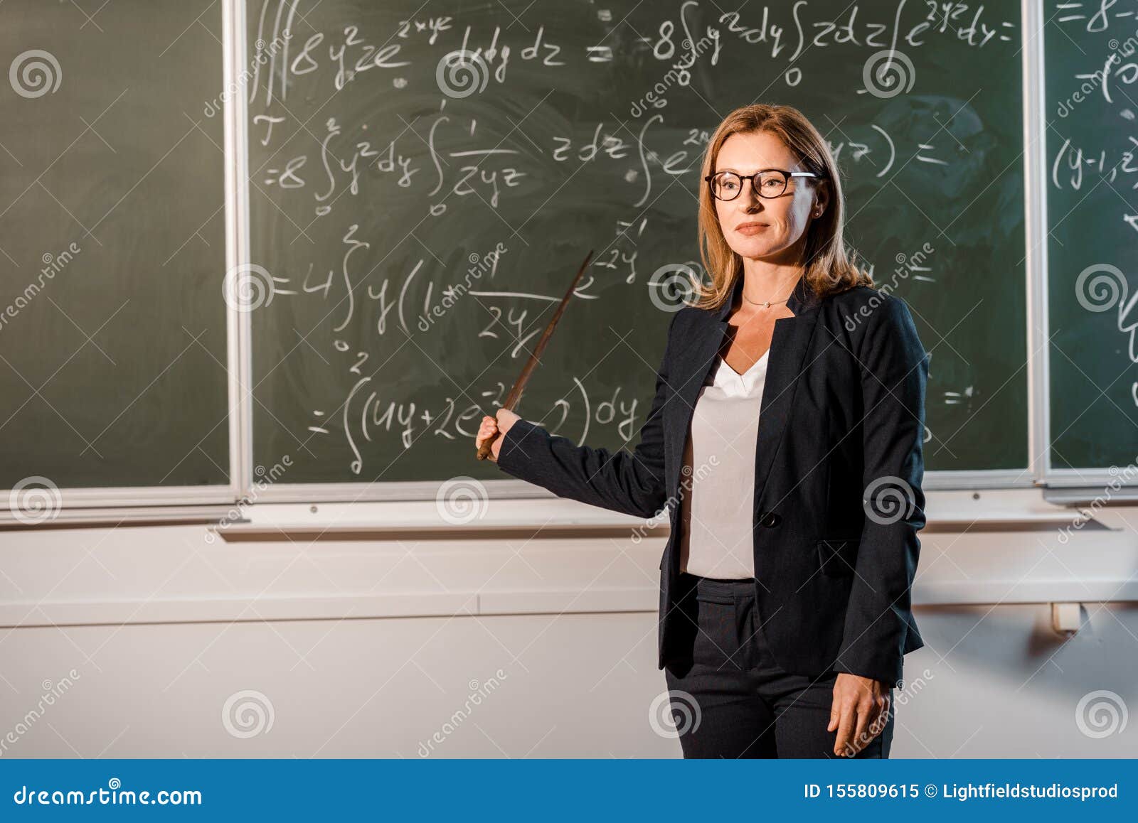 Beautiful Female Teacher with Wooden Pointer Explaining Mathematical ...