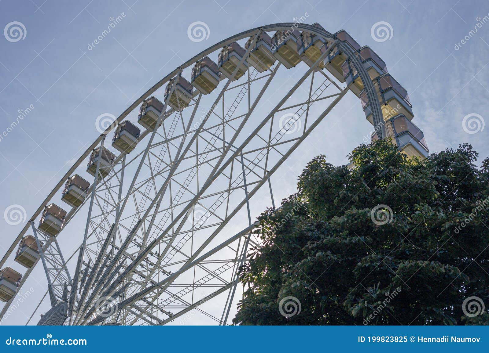 Beautiful Ferris Wheel with White Cabs on a Background of Blue Sky ...