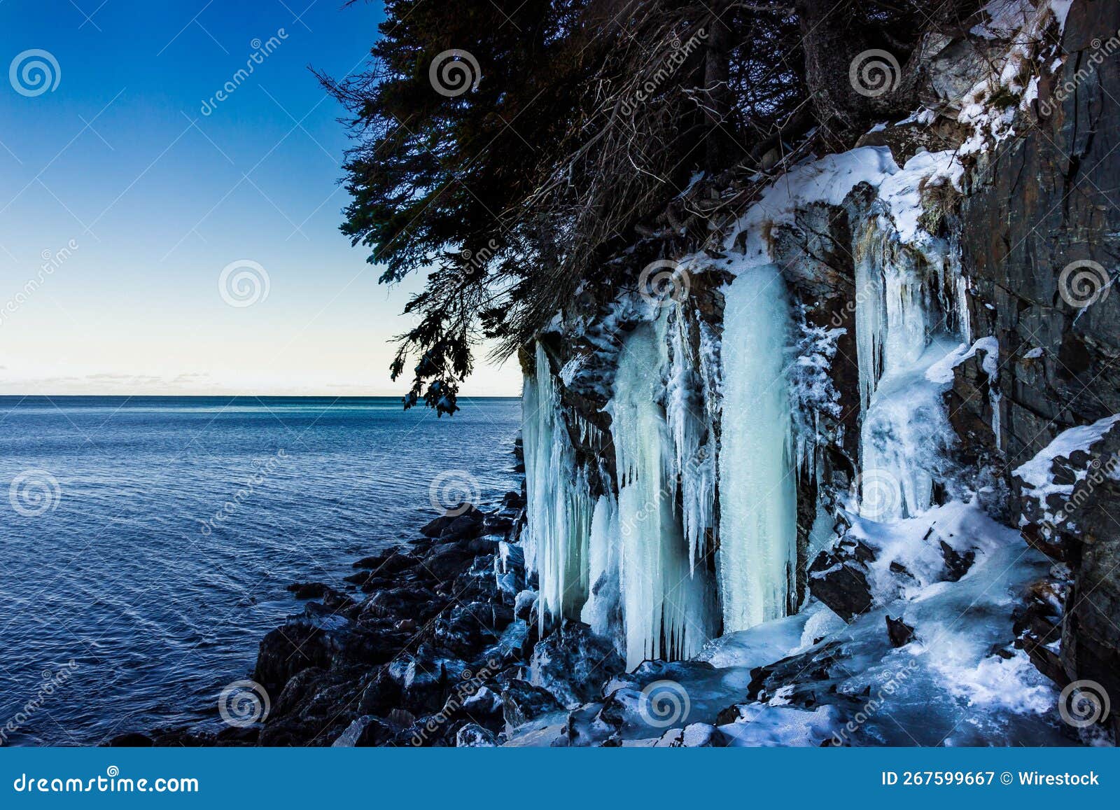 Beautiful Frozen Waterfall Against a Rocky Shore Stock Image - Image of ...