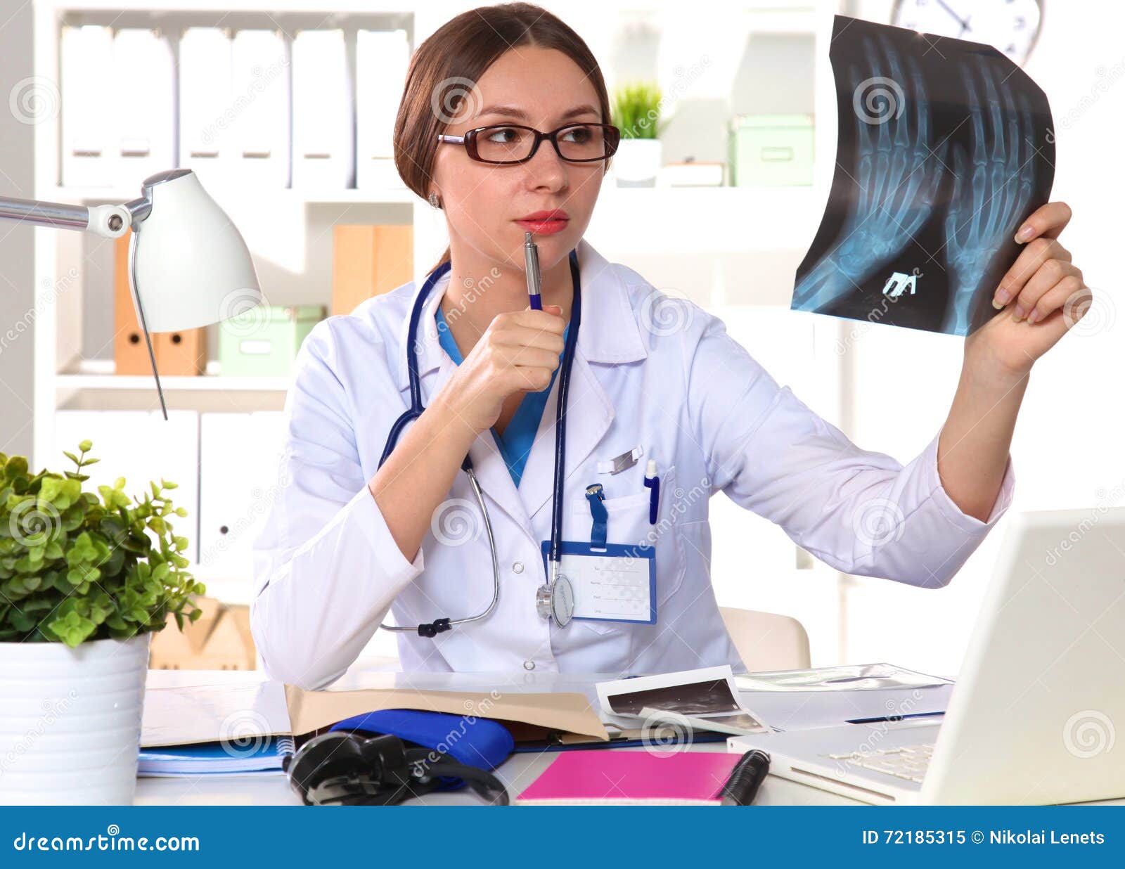 Beautiful General Practitioner is Working with Joy. she is Standing ...