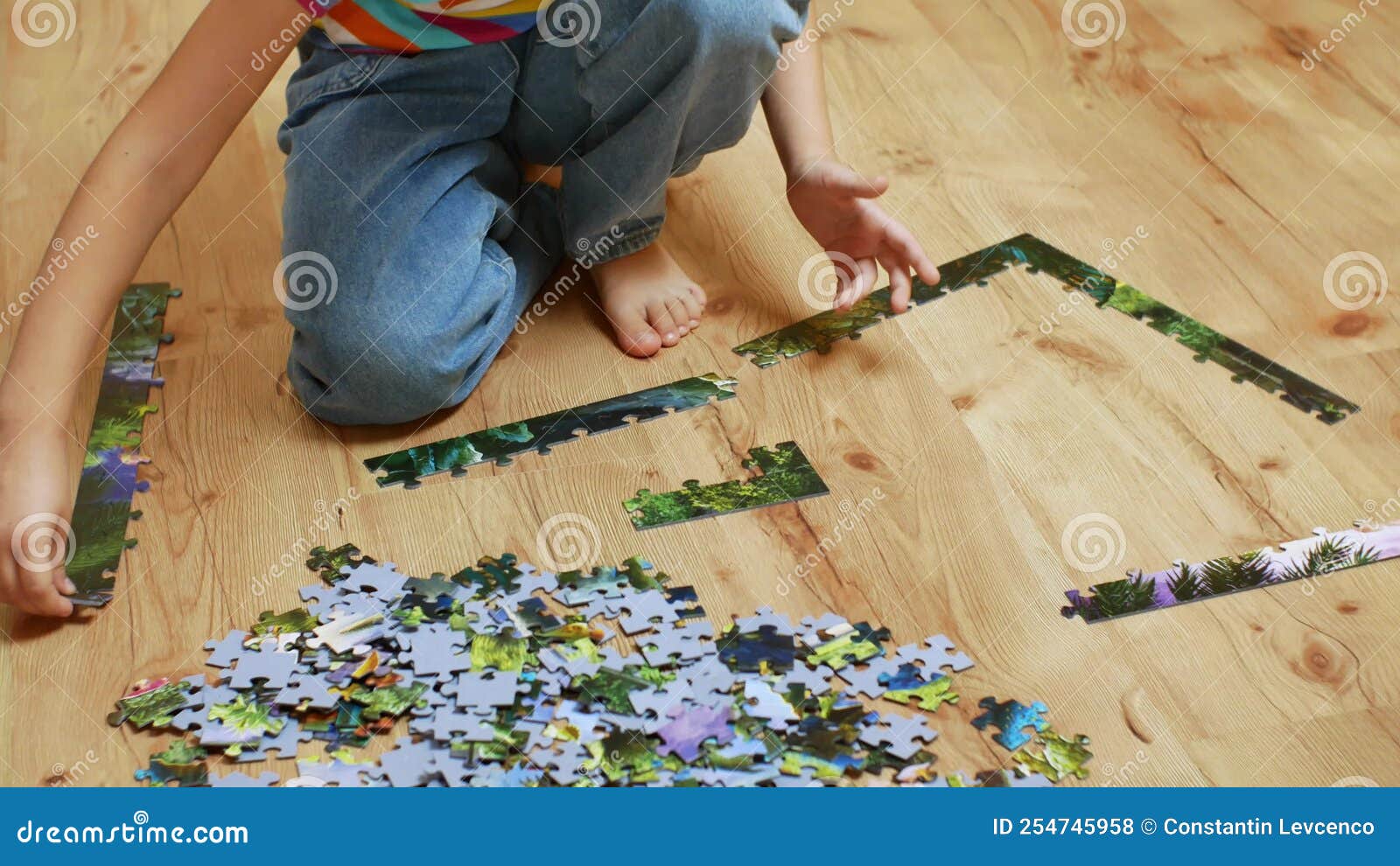 A Beautiful Girl Collects Puzzle Puzzles Sitting on a Wooden Floor ... A Beautiful Girl Collects Puzzle Puzzles Sitting on a Wooden Floor ...