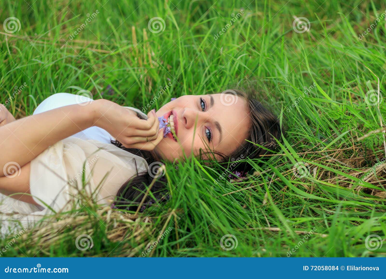 Beautiful girl in a field. stock photo. Image of grass - 72058084
