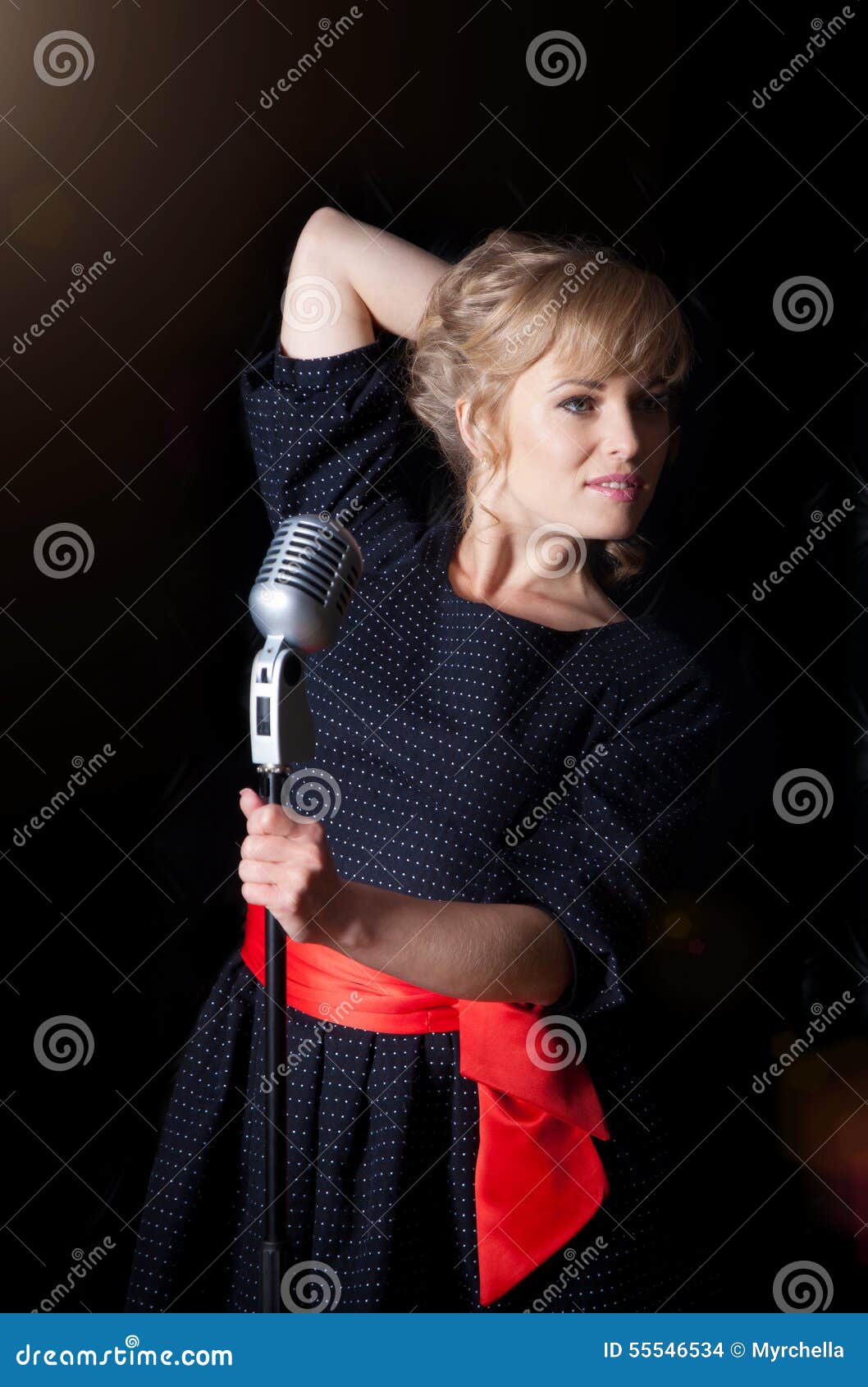 Beautiful Girl with a Microphone on Stage Stock Photo - Image of ...