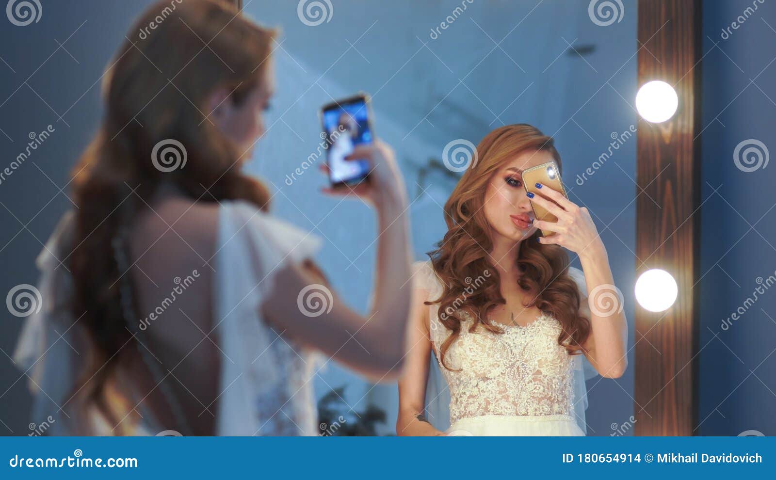 Beautiful Girl Model Posing In Front Of A Mirror And Taking Pictures On