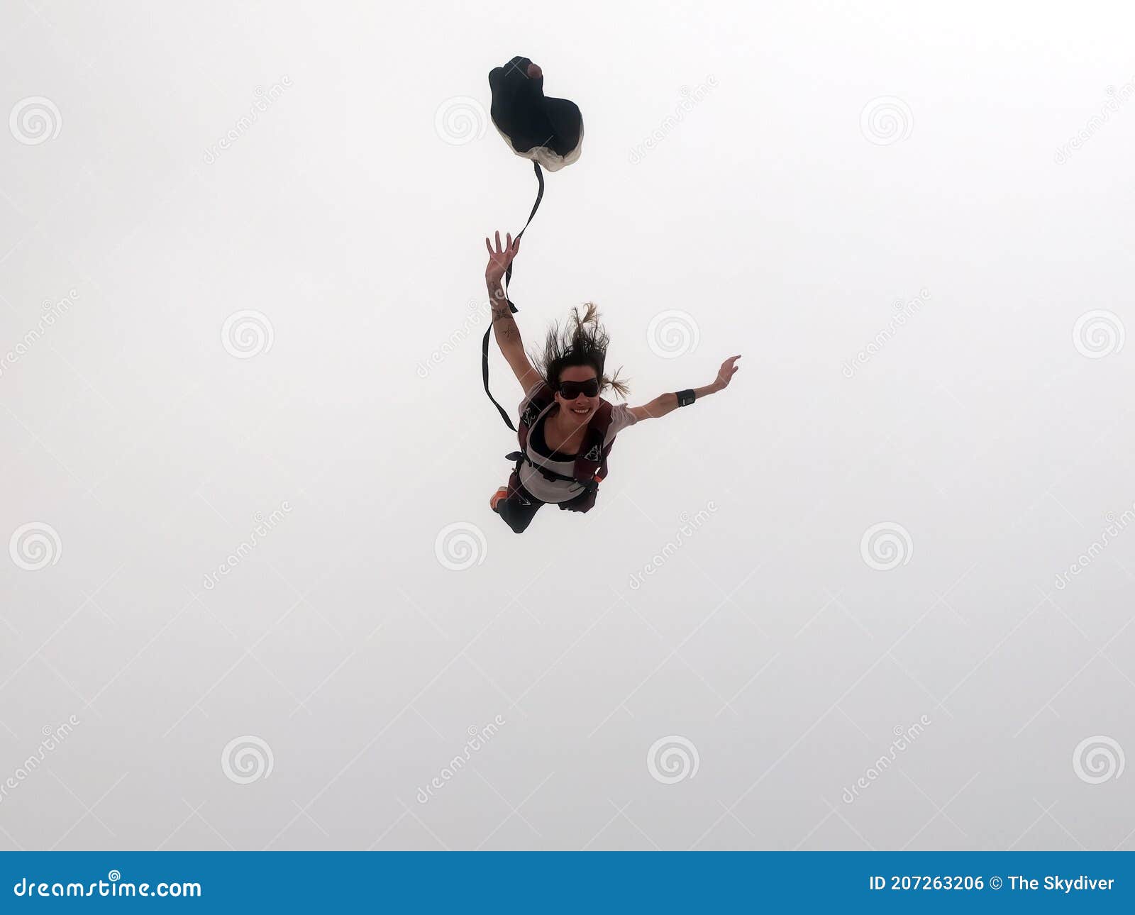 A Beautiful Girl Opening Her Parachute into the Clouds Stock Photo ...