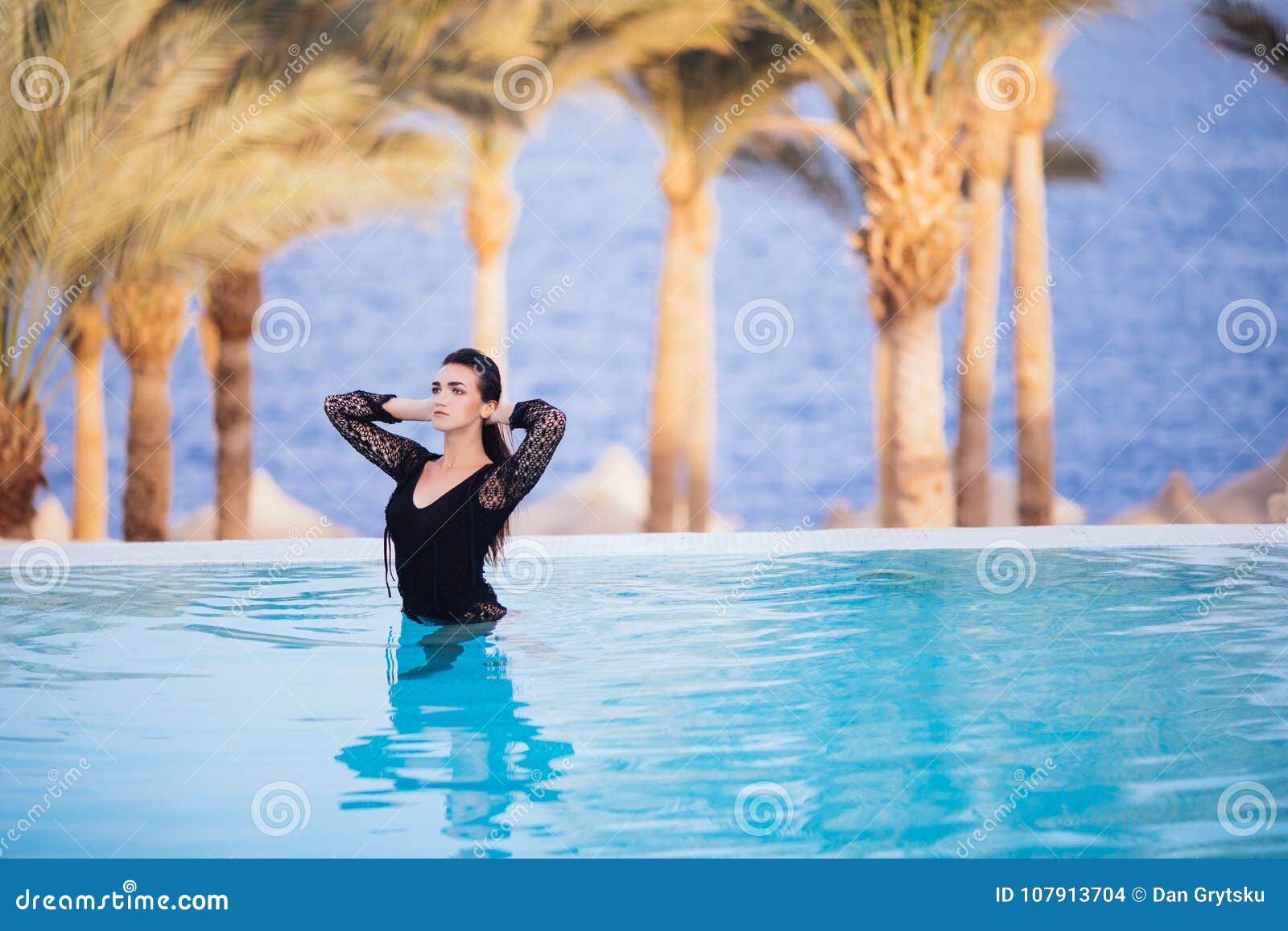 Beautiful Girl is Relaxing in an Infinity Pool on Summer View Stock ...