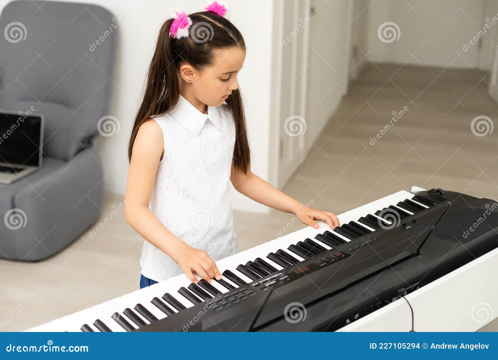 Beautiful Girl Sings while Playing on an Electronic Piano Stock Photo ...