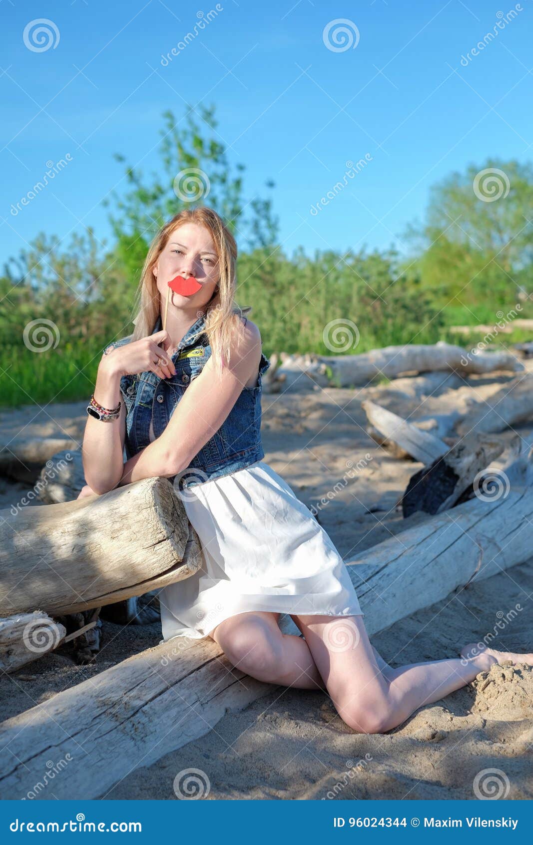 Beautiful Girl Sitting on a Log at the Beach Stock Photo - Image of ...
