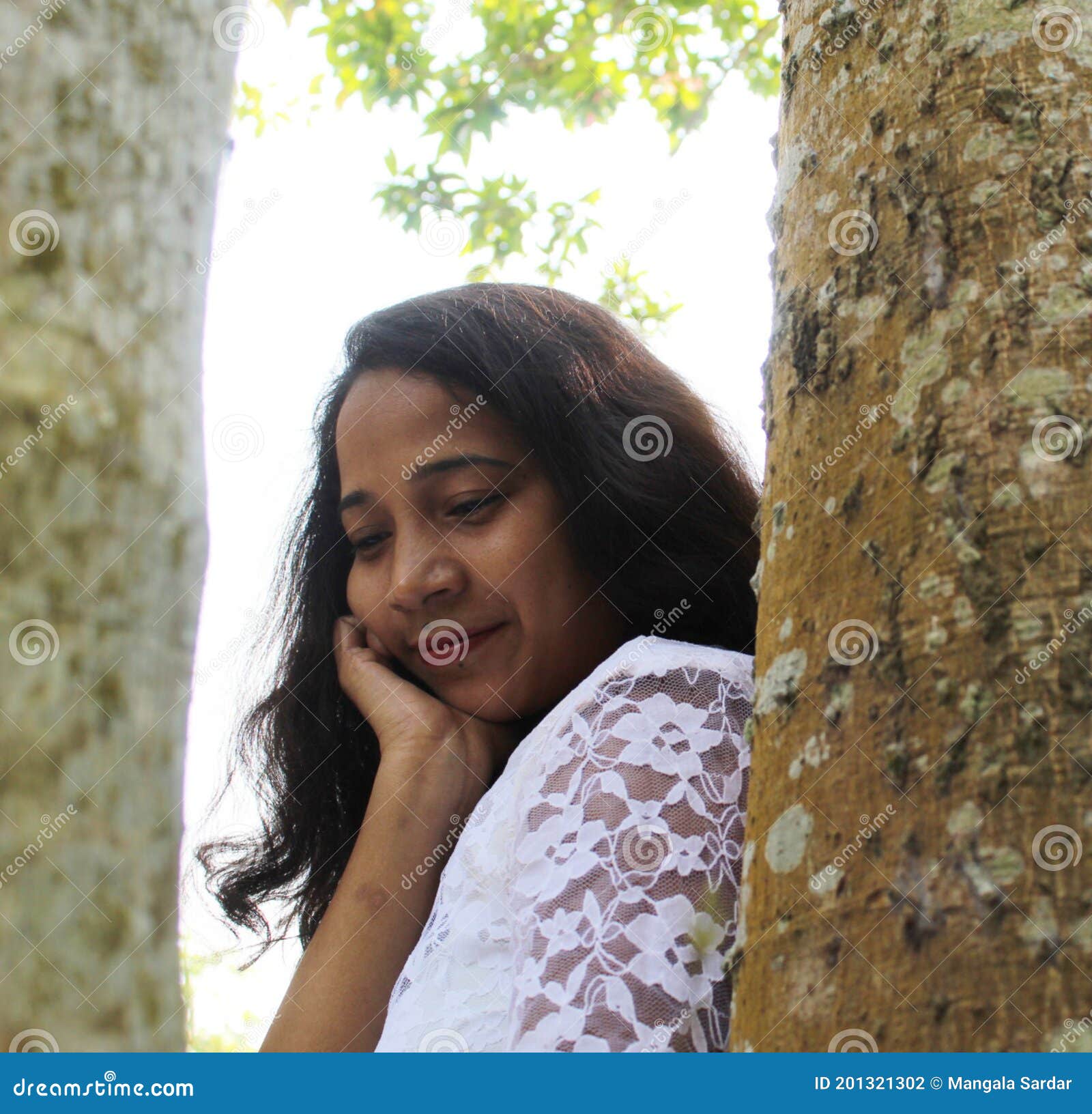 The Beautiful Girl is Sitting Under a Tree Stock Photo - Image of tree ...