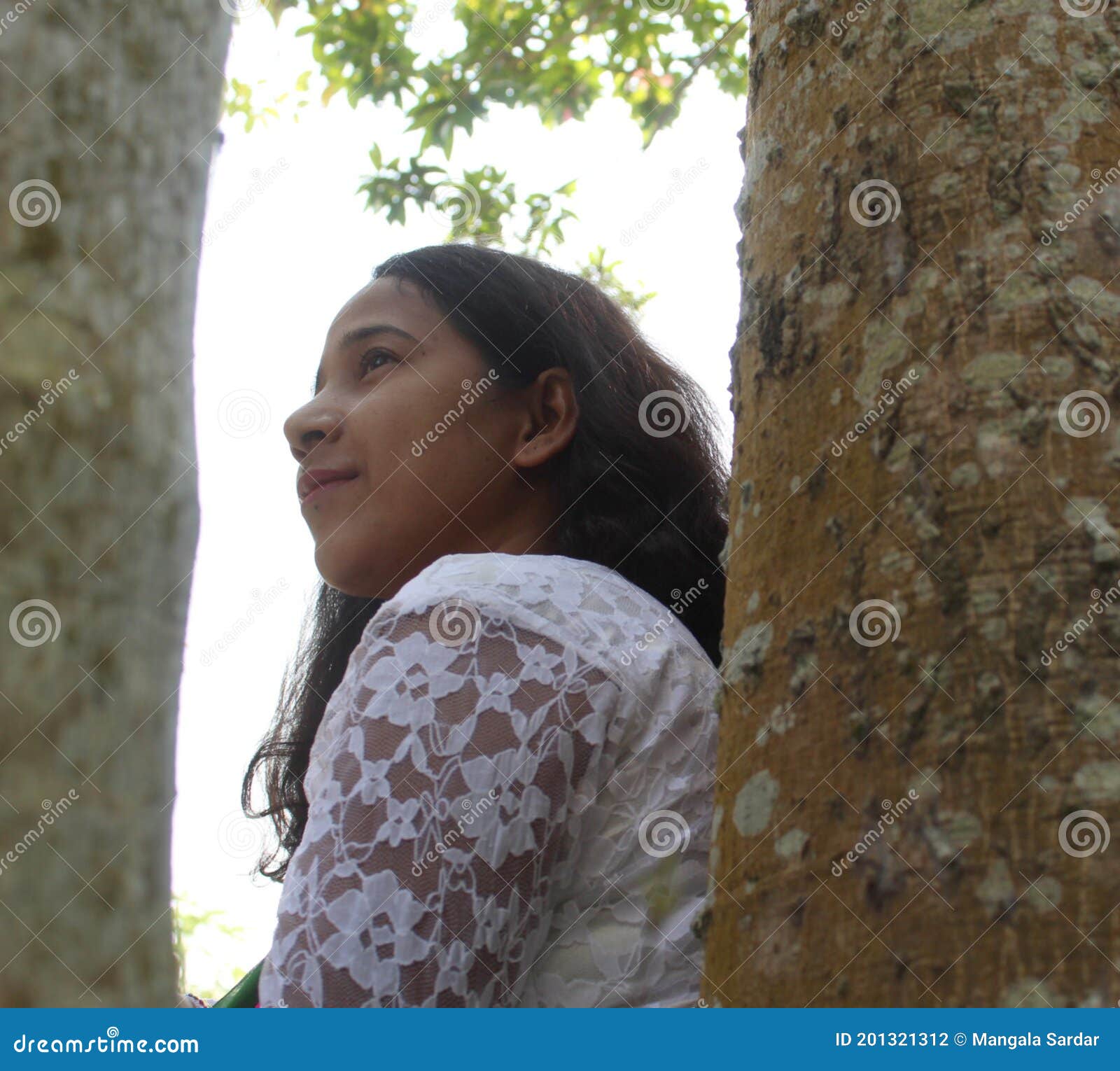 The Beautiful Girl is Sitting Under a Tree Stock Photo - Image of ...