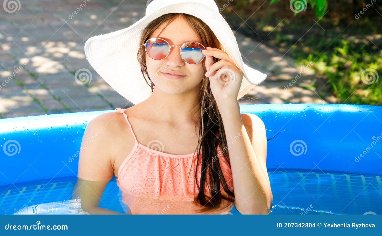 Beautiful Girl In Sunglasses And Hat Relaxing In Swimming Pool Stock