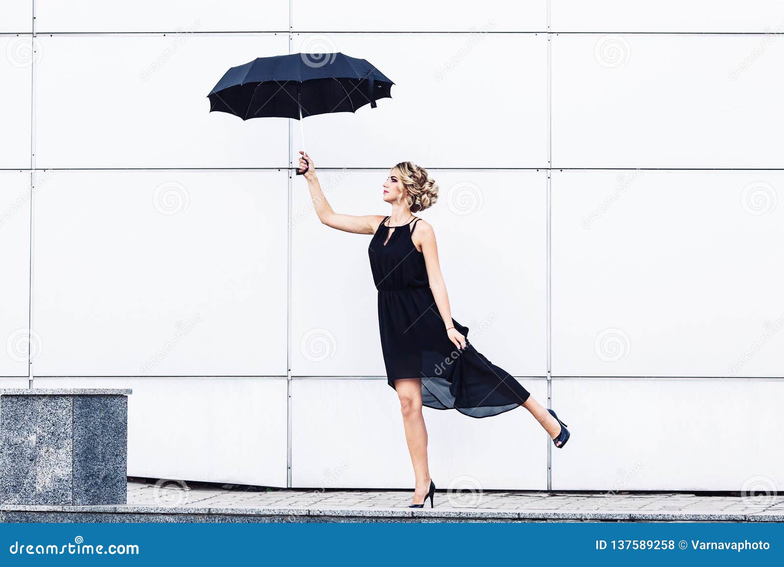 Beautiful Girl with Umbrella Blows the Wind. Stock Photo - Image of ...