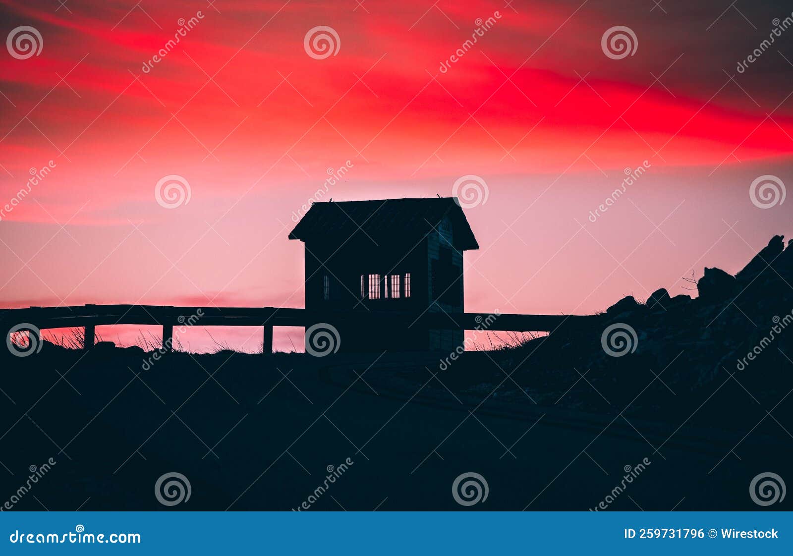 Beautiful Glowing Red Sunset Sky Over a Little House in the Mountains ... Beautiful Glowing Red Sunset Sky Over a Little House in the Mountains ...