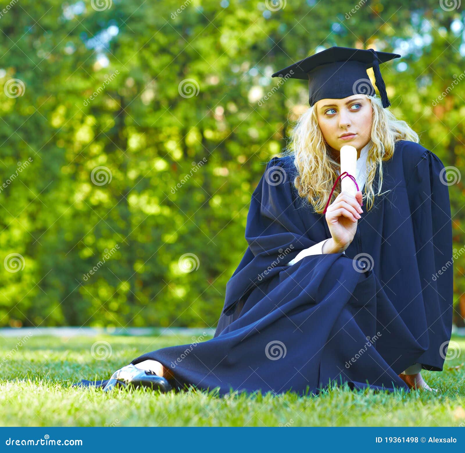 A Beautiful Graduate Sitting on the Lawn Stock Photo - Image of ...