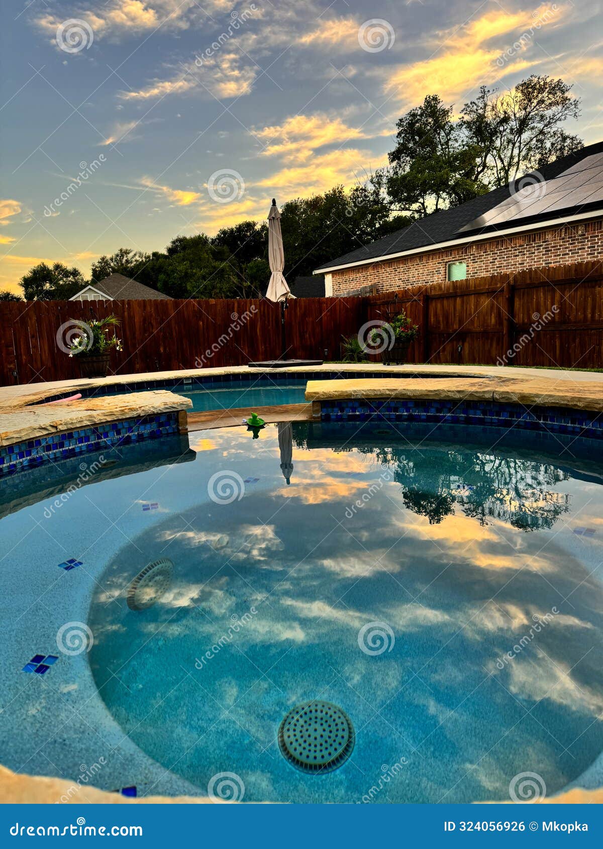 Beautiful in-ground Swimming Pool in a Residential Backyard at Sunset ...