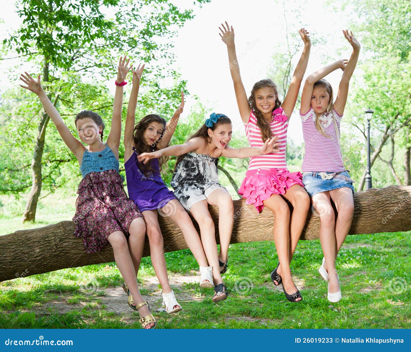 Beautiful Happy Girls Sitting on a Tree Trunk Stock Image - Image of ...