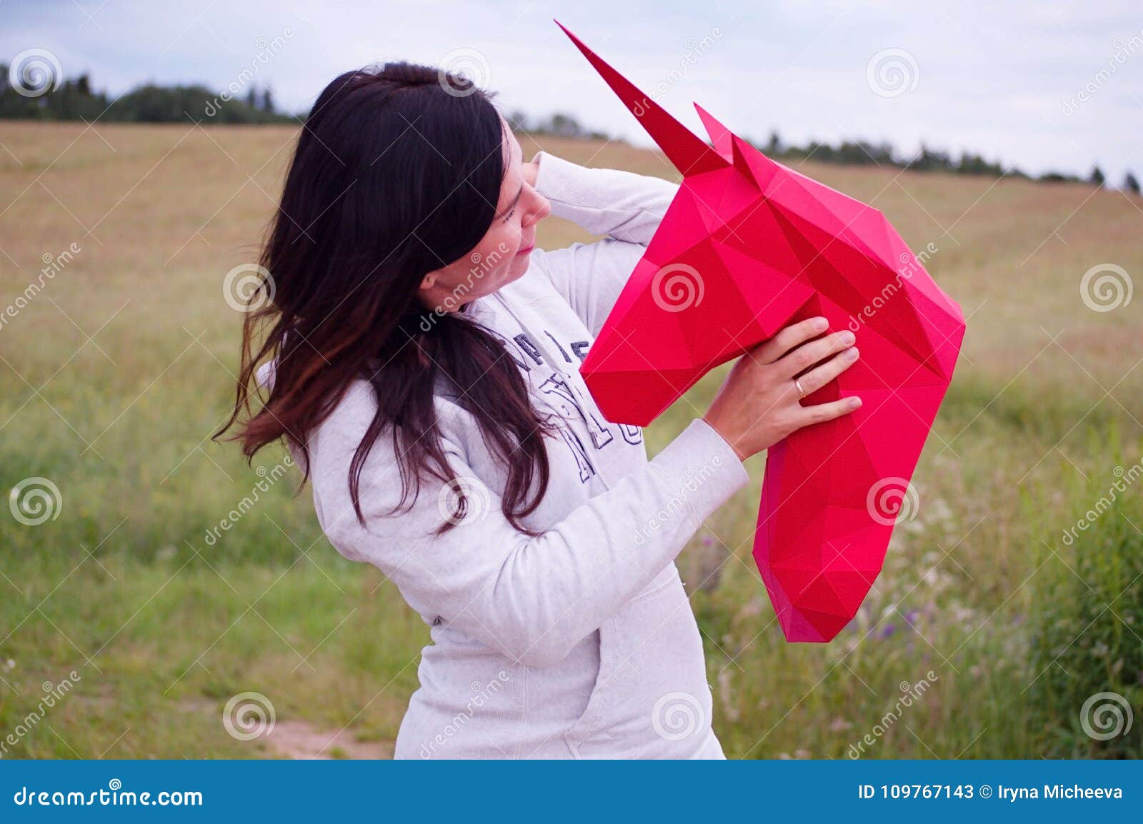 Beautiful Happy Smiling Young Girl with Red Paper Unicorn. Meadow and ... Beautiful Happy Smiling Young Girl with Red Paper Unicorn. Meadow and ...