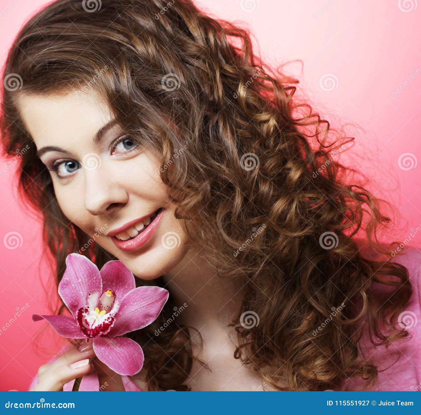 Beautiful Happy Woman With Orchid Flower Over Pink Background Stock