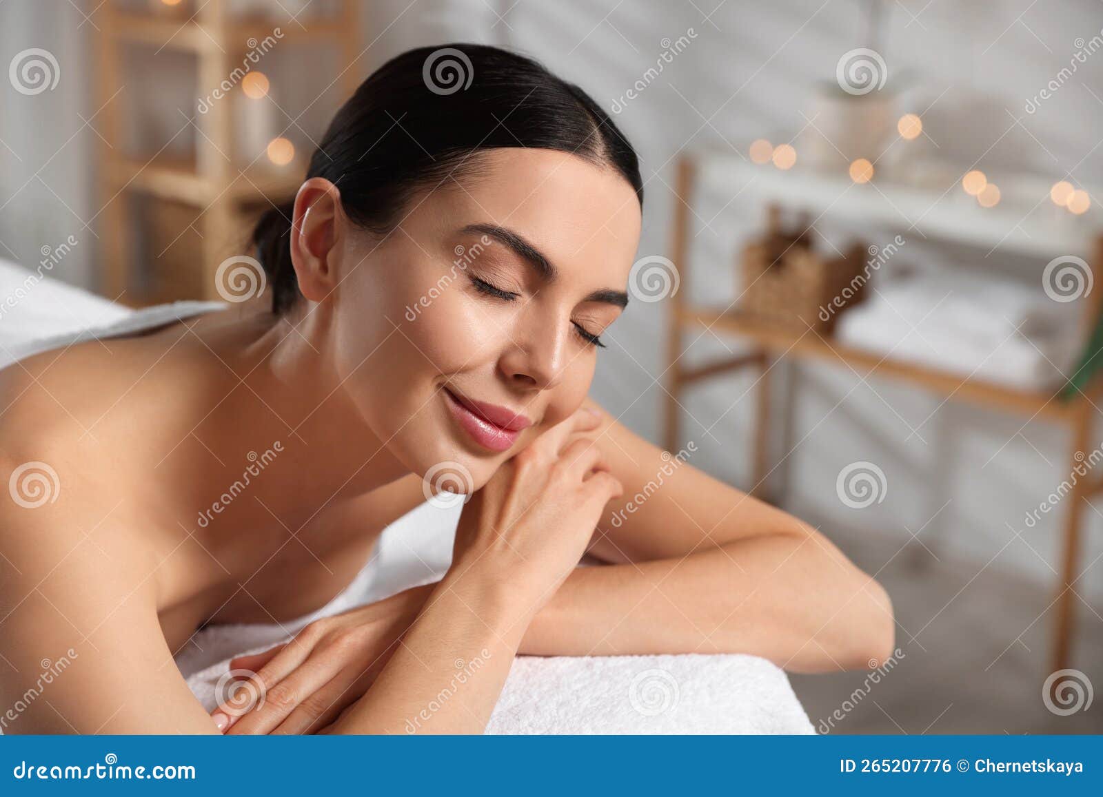 Beautiful Happy Woman Relaxing On Massage Table In Spa Salon Stock
