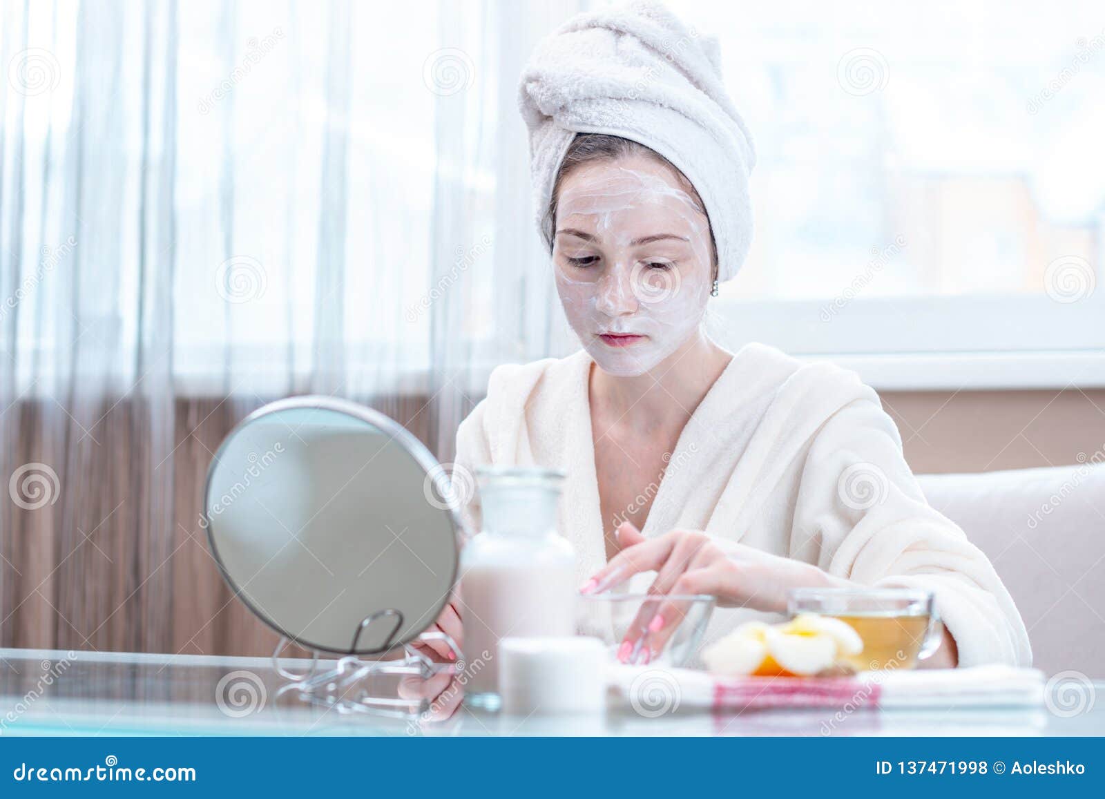 Beautiful Woman Applying Cream Of Natural Cosmetics On Face