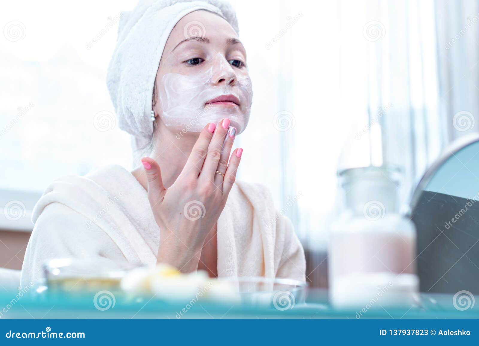 Beautiful Woman Applying Cream Of Natural Cosmetics On Face