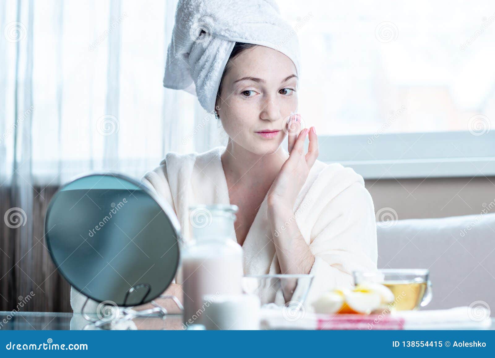 Beautiful Young Woman Applying Cream Of Natural Cosmetics On Face