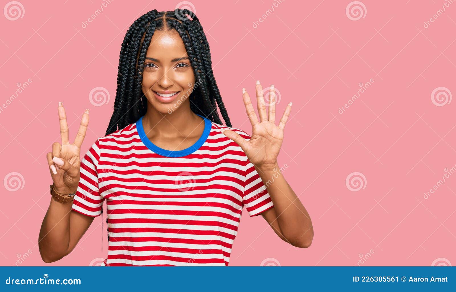 Beautiful Hispanic Woman Wearing Casual Clothes Showing And Pointing Up