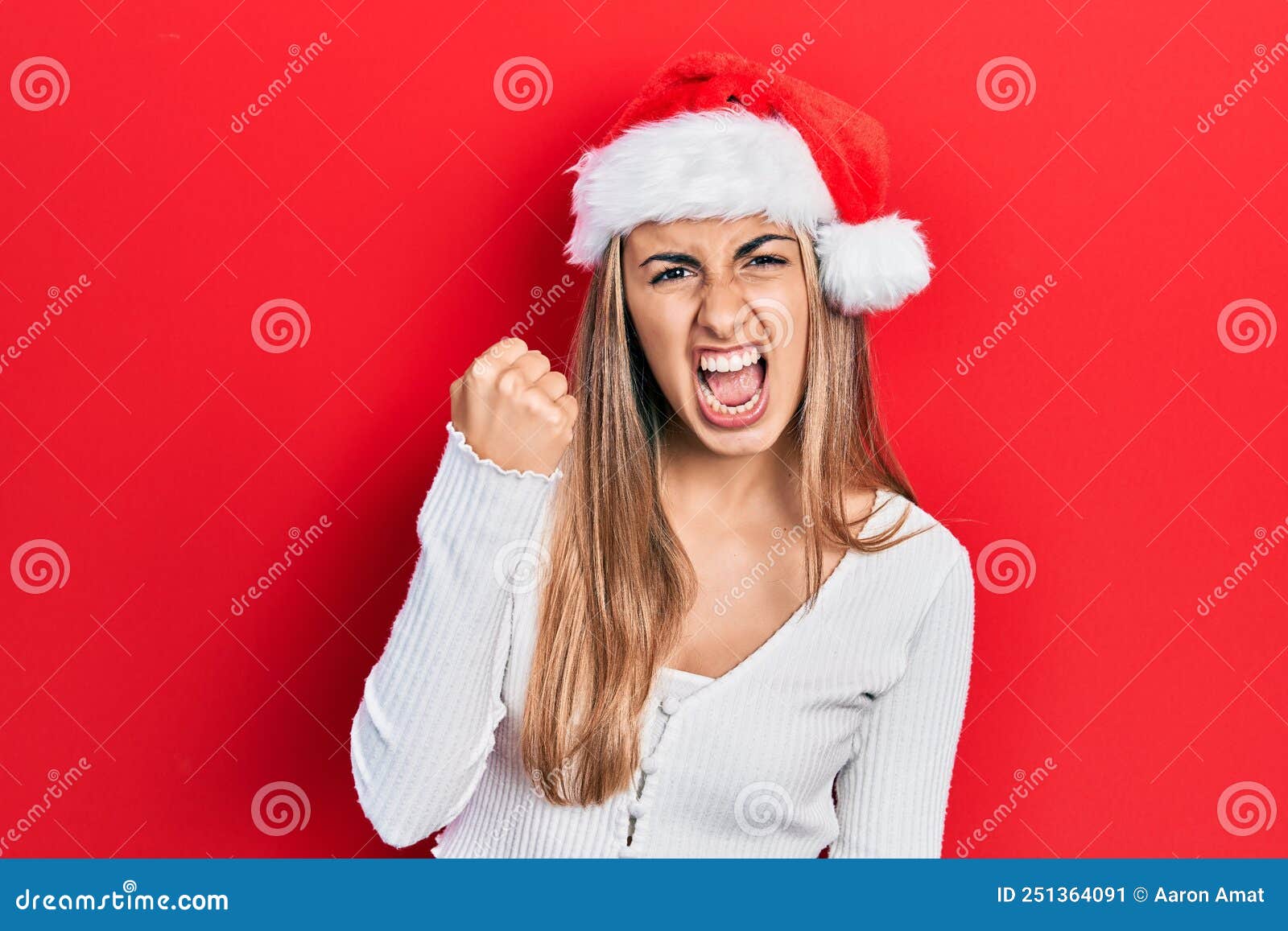 Beautiful Hispanic Woman Wearing Christmas Hat Angry And Mad Raising