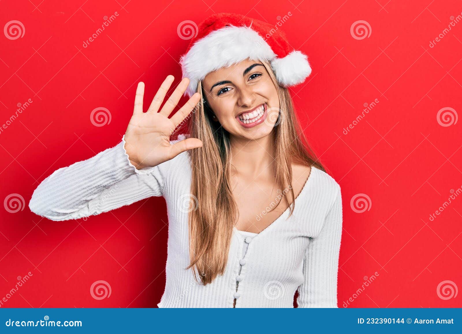 Beautiful Hispanic Woman Wearing Christmas Hat Showing And Pointing Up