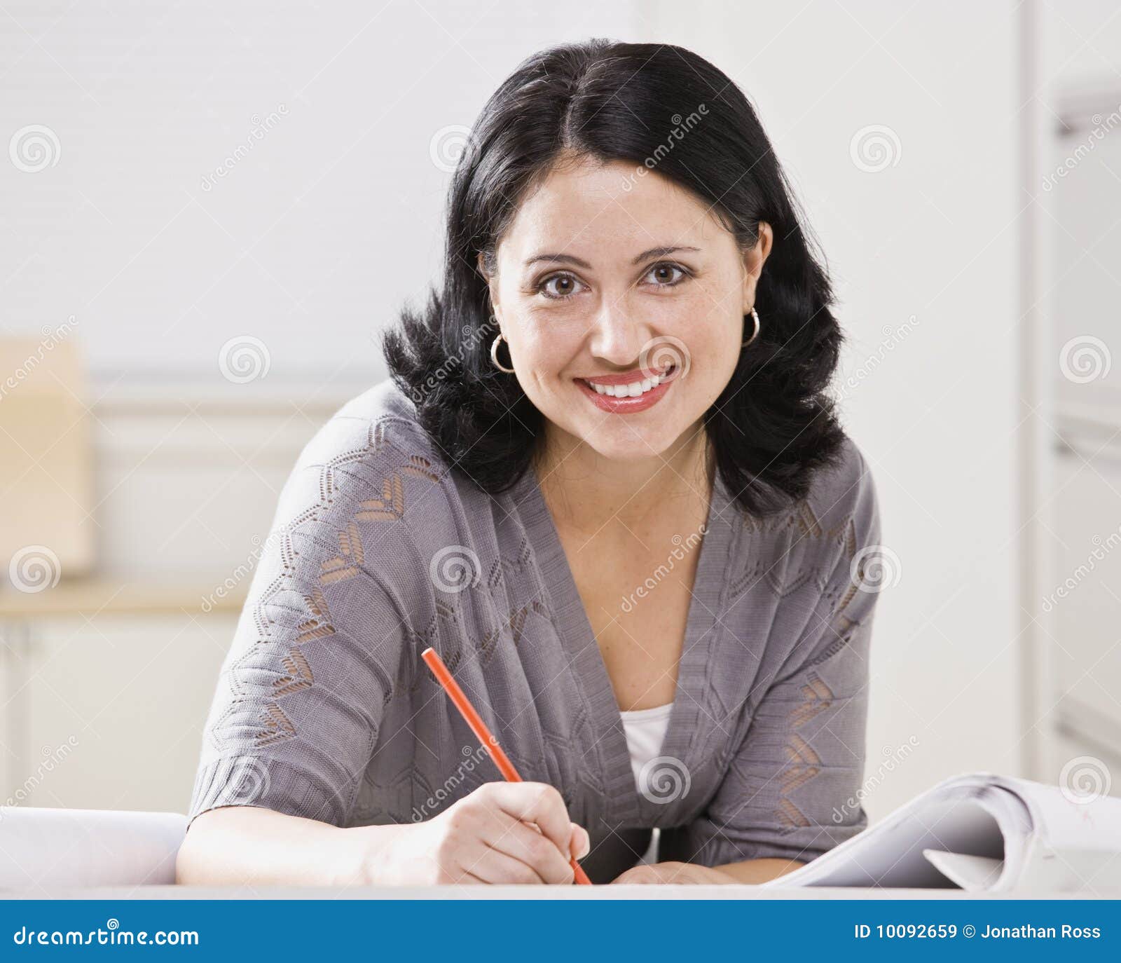Beautiful Hispanic Woman Writing Stock Image - Image of fifties, seated ...