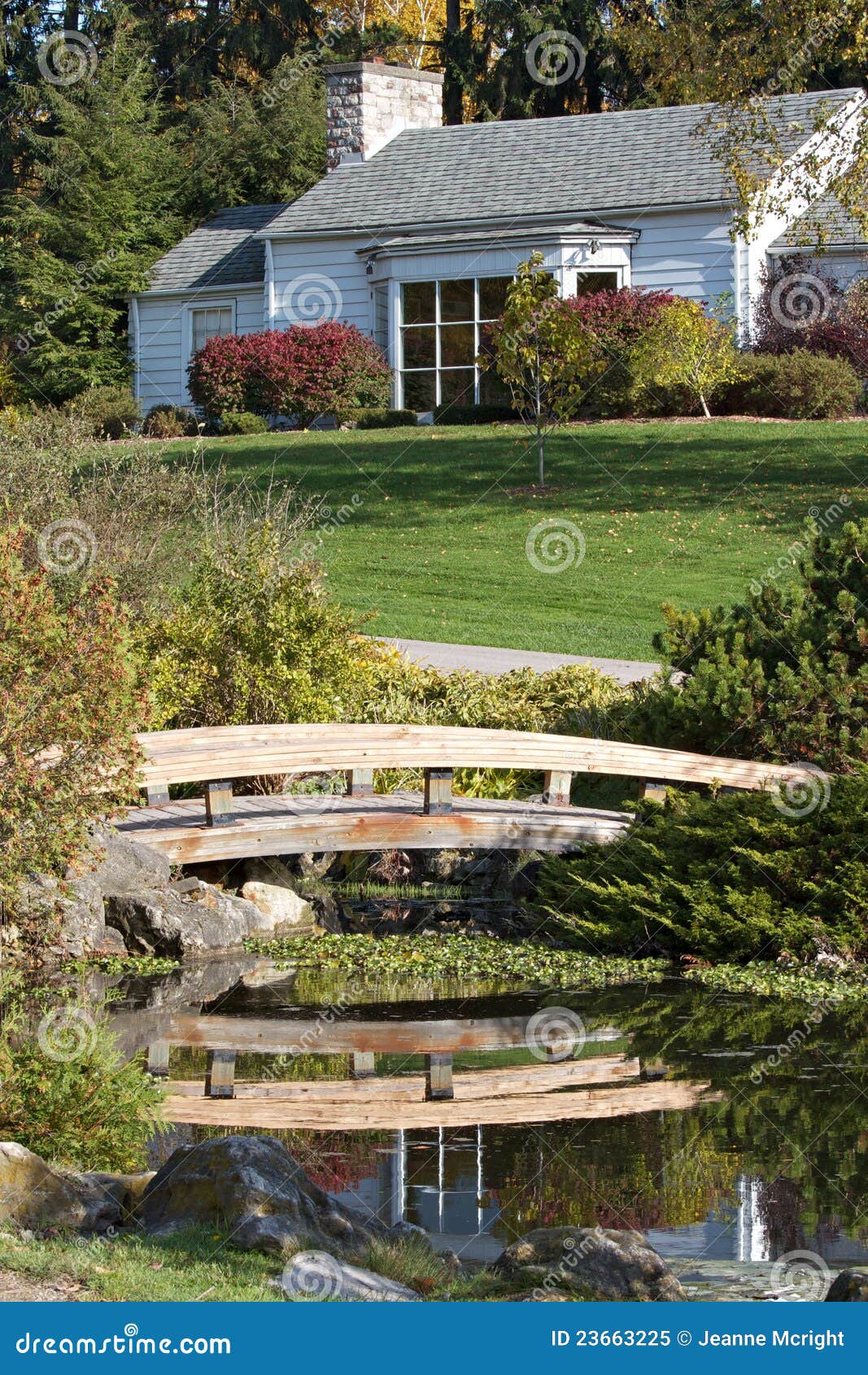 Beautiful Home with Footbridge Over Pond Stock Image - Image of autumn ...