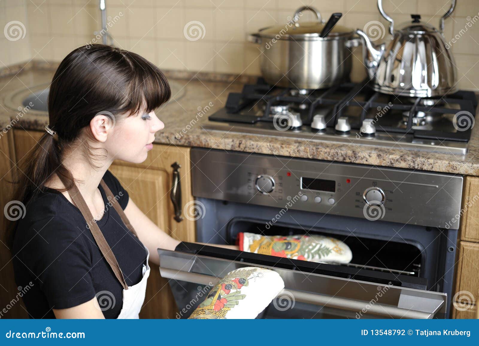 Beautiful Housewife Using the Oven Stock Photo - Image of apron ...