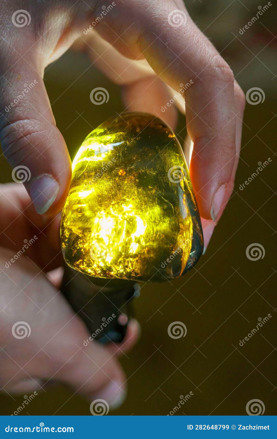 Beautiful Illuminated Amber Held between Fingertips Stock Image - Image ...