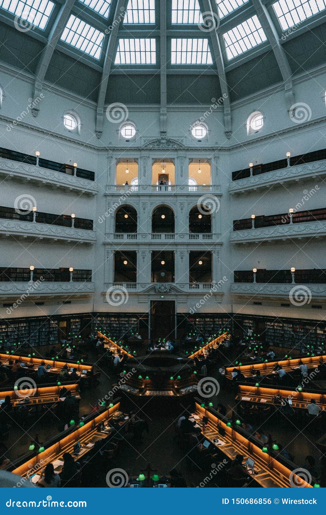 Beautiful Interior of a Large Library with People Working on Laptops ...